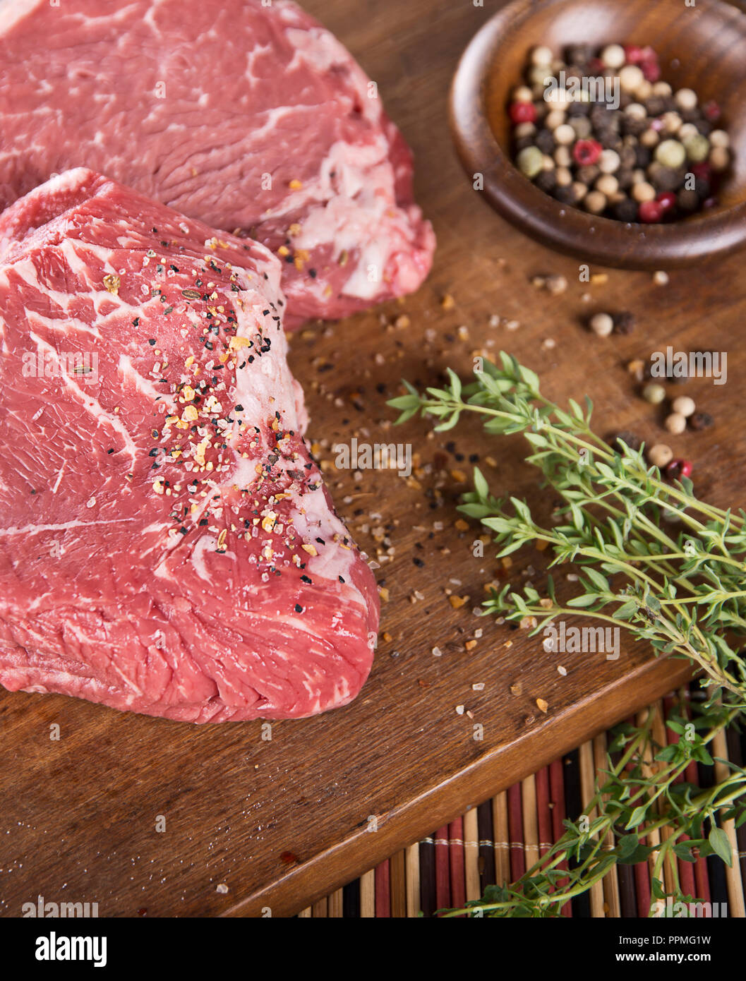 Raw beef steak with herbs and spices Stock Photo - Alamy
