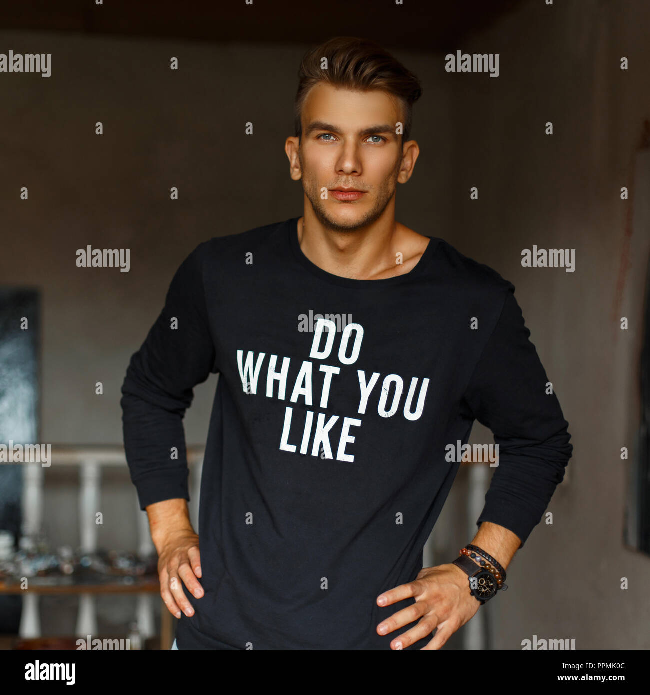 Handsome young American model man with a hairdo in a black pullover ...