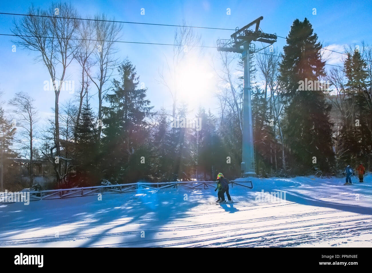 ski resort panorama with ski lift cabin, slope and snow mountains ...