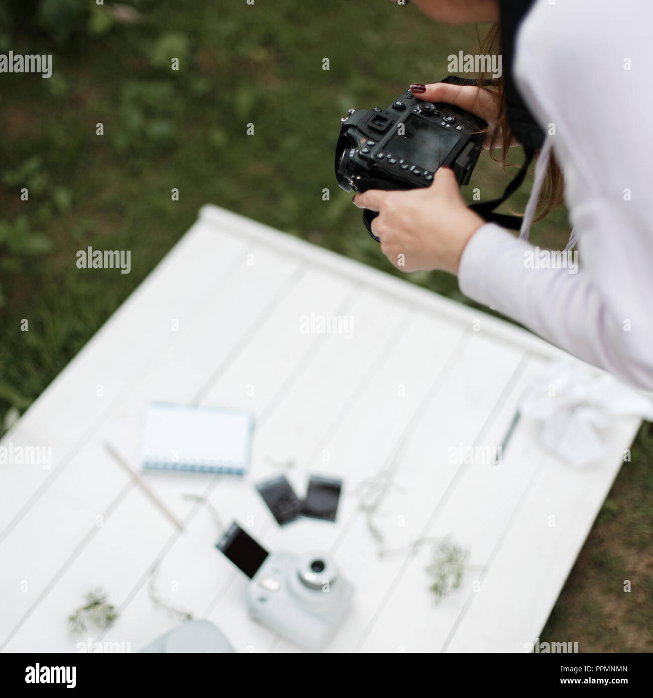 Girl photographer takes pictures of objects. Female hands hold the ...