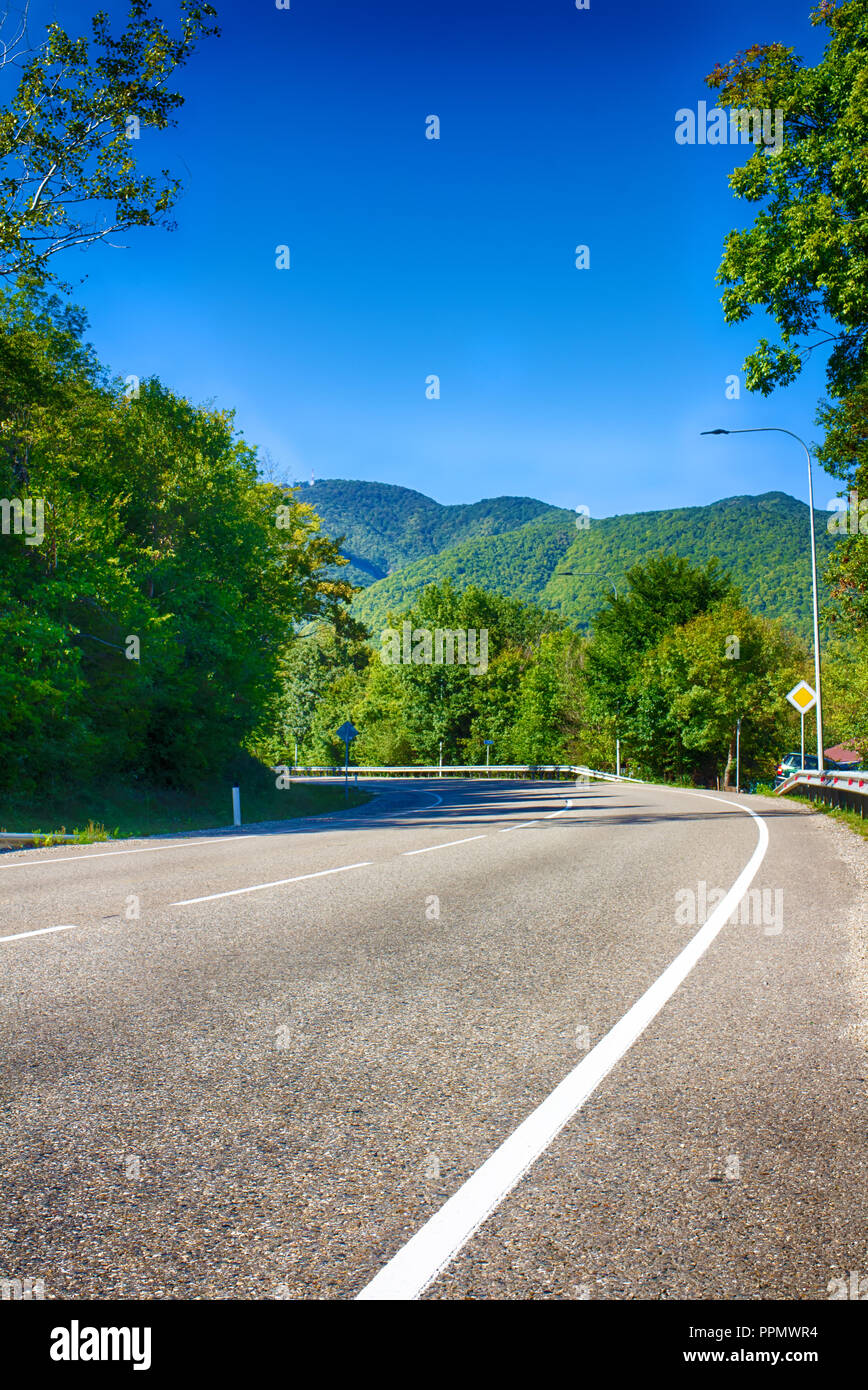 The road in mountainous terrain, sharp turns. Summer landscape ...