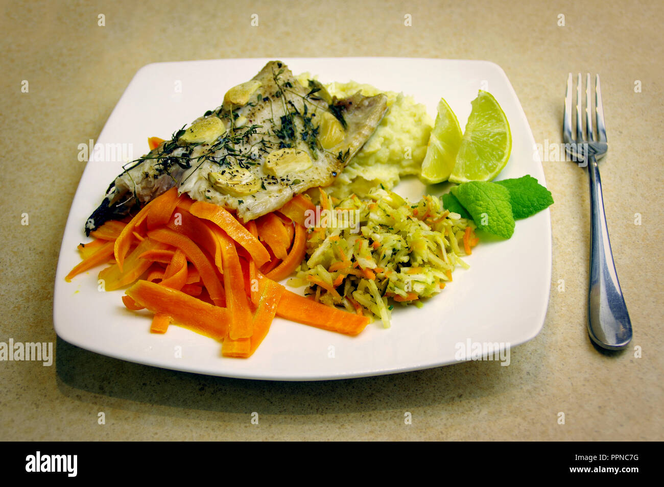 Roast fish with carrot pasta and salad. Fresh trout from the oven with ...