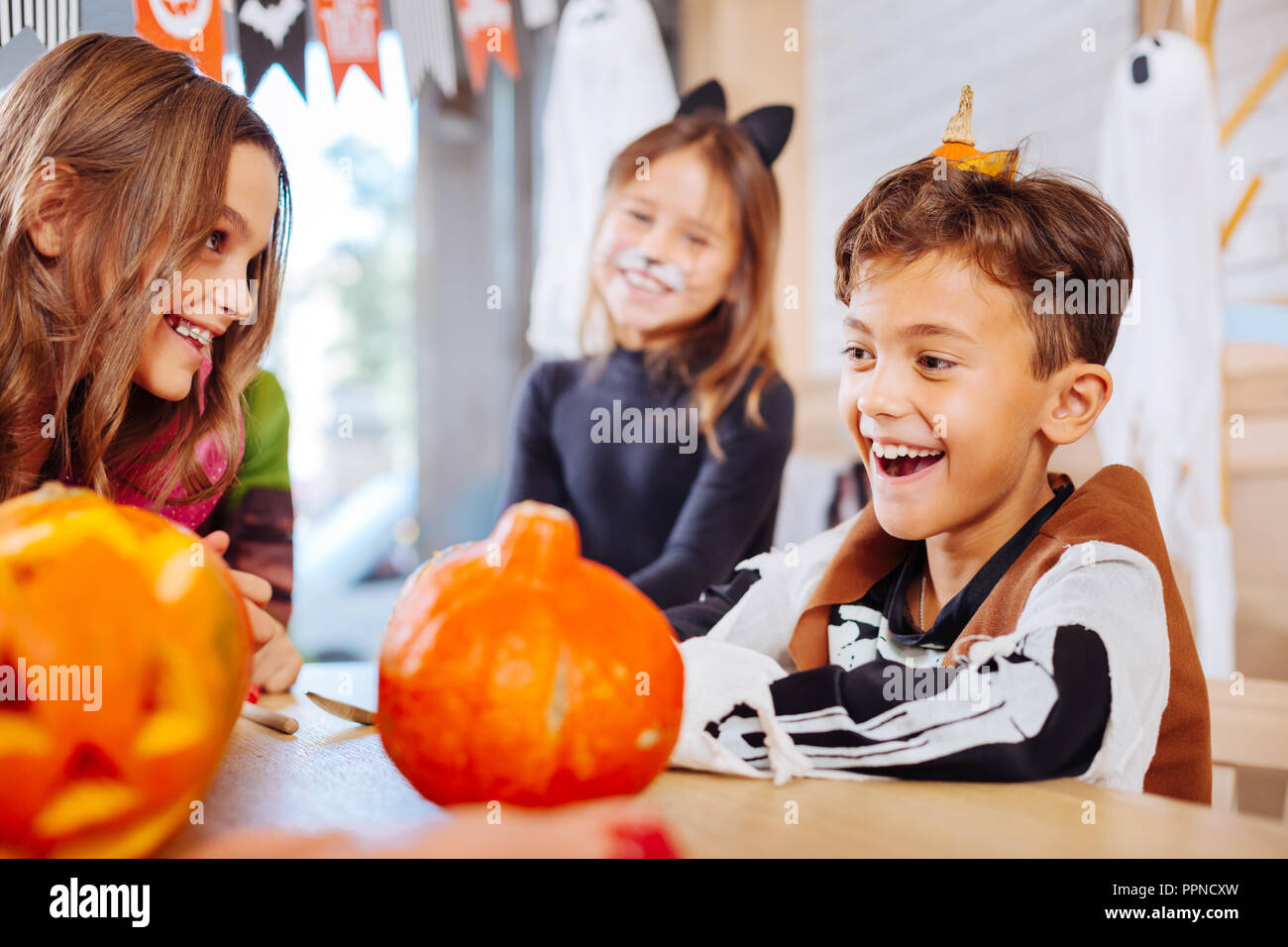 Handsome smiling schoolboy wearing skeleton costume for Halloween party ...
