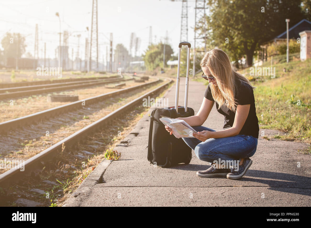 Woman on railway station searching in map for next destination Stock ...