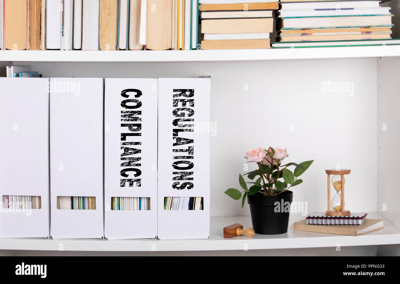 Compliance and Regulations concept. document folders and organizers ...