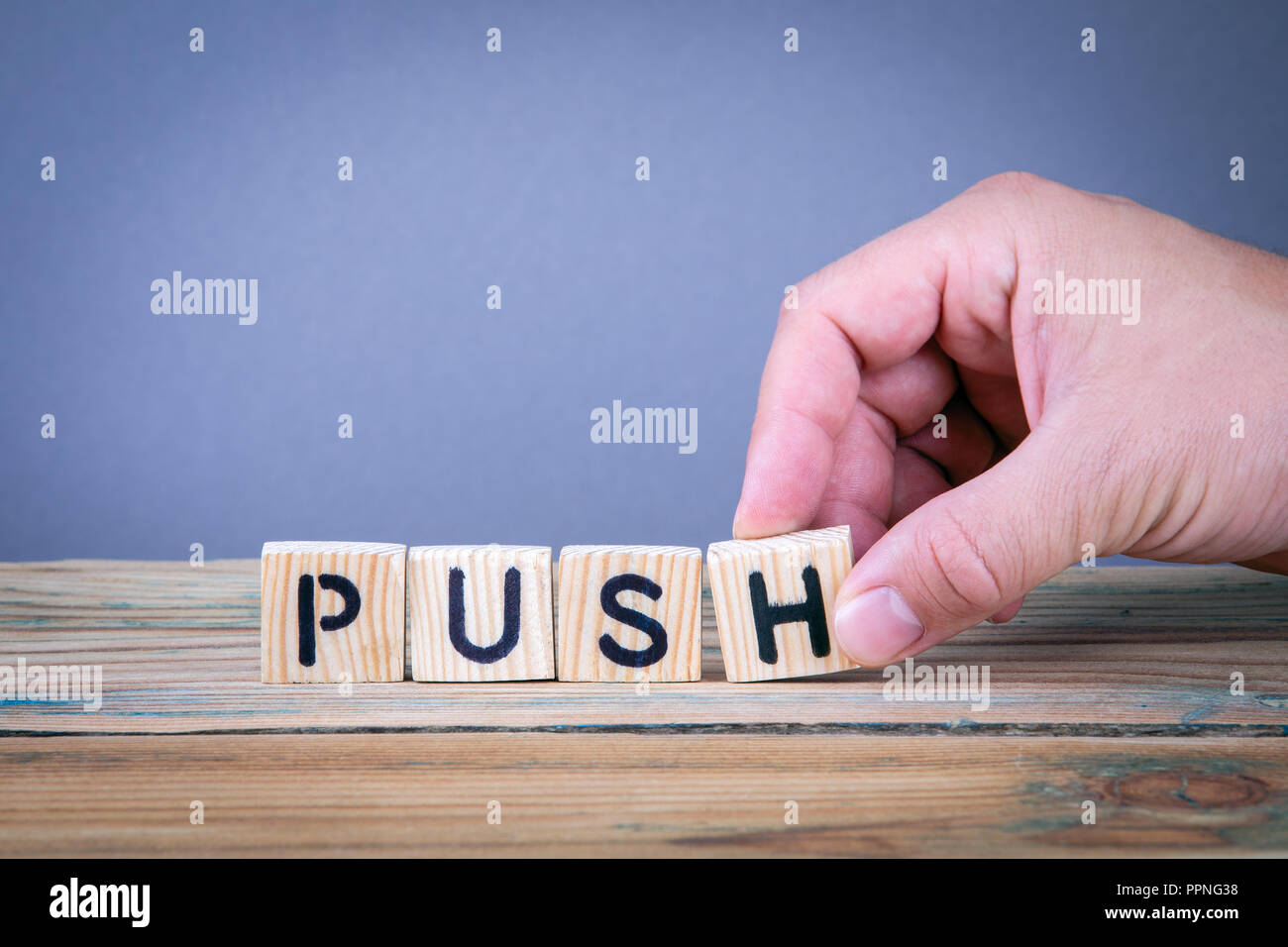 push. Wooden letters on the office desk Stock Photo - Alamy