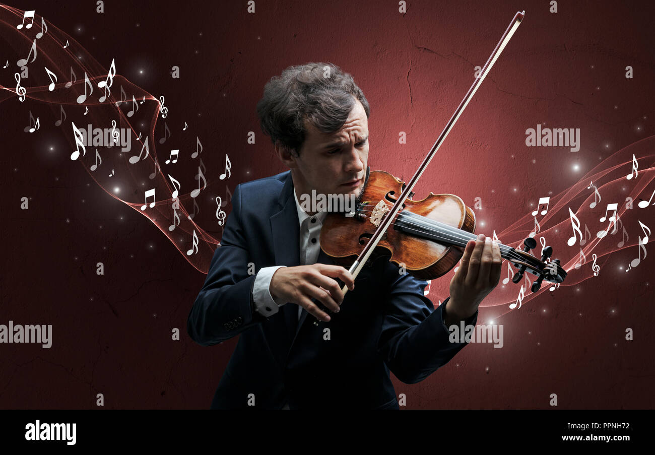 Lonely musical composer with violin and sparkling musical notes around ...