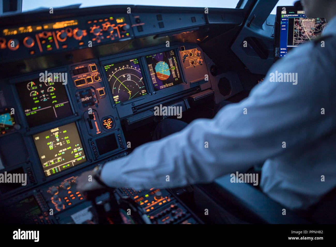 Pilot's hand accelerating on the throttle in a commercial airliner ...