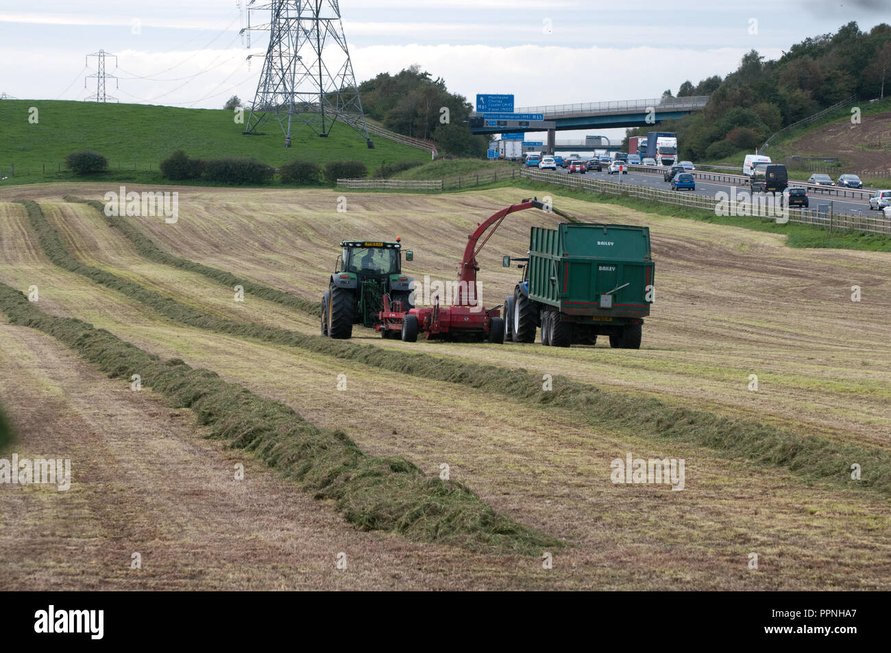Around the UK - Collecting Silage in a field adjacent to the M65 ...