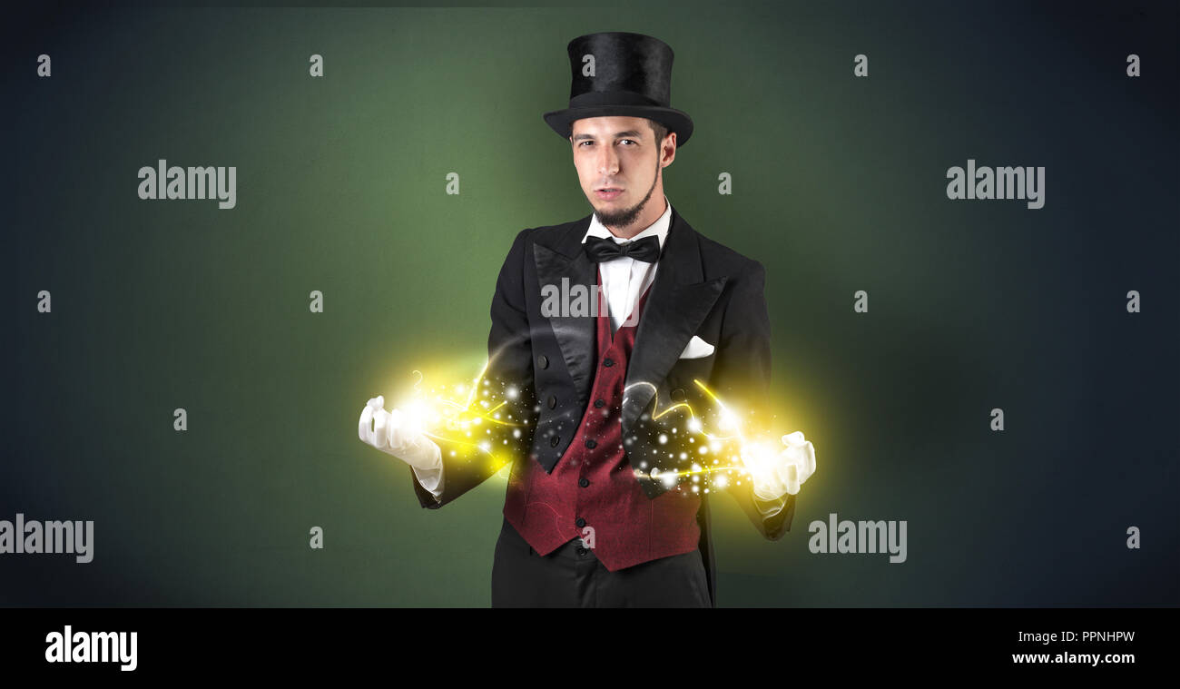 Magician holding his sparkling power between his two hand Stock Photo ...