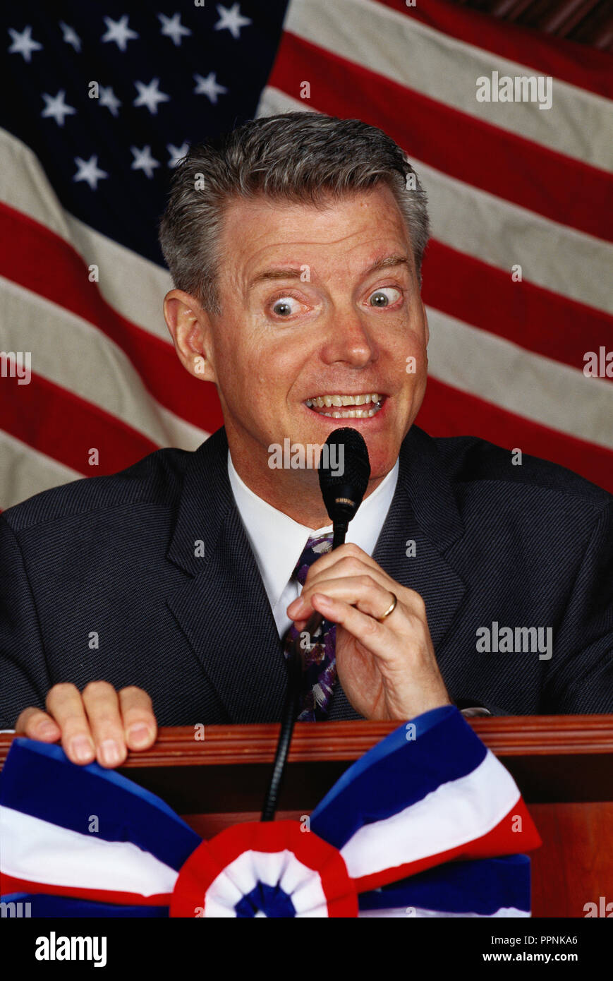 Political candidate speaking in front of an American flag, USA Stock ...