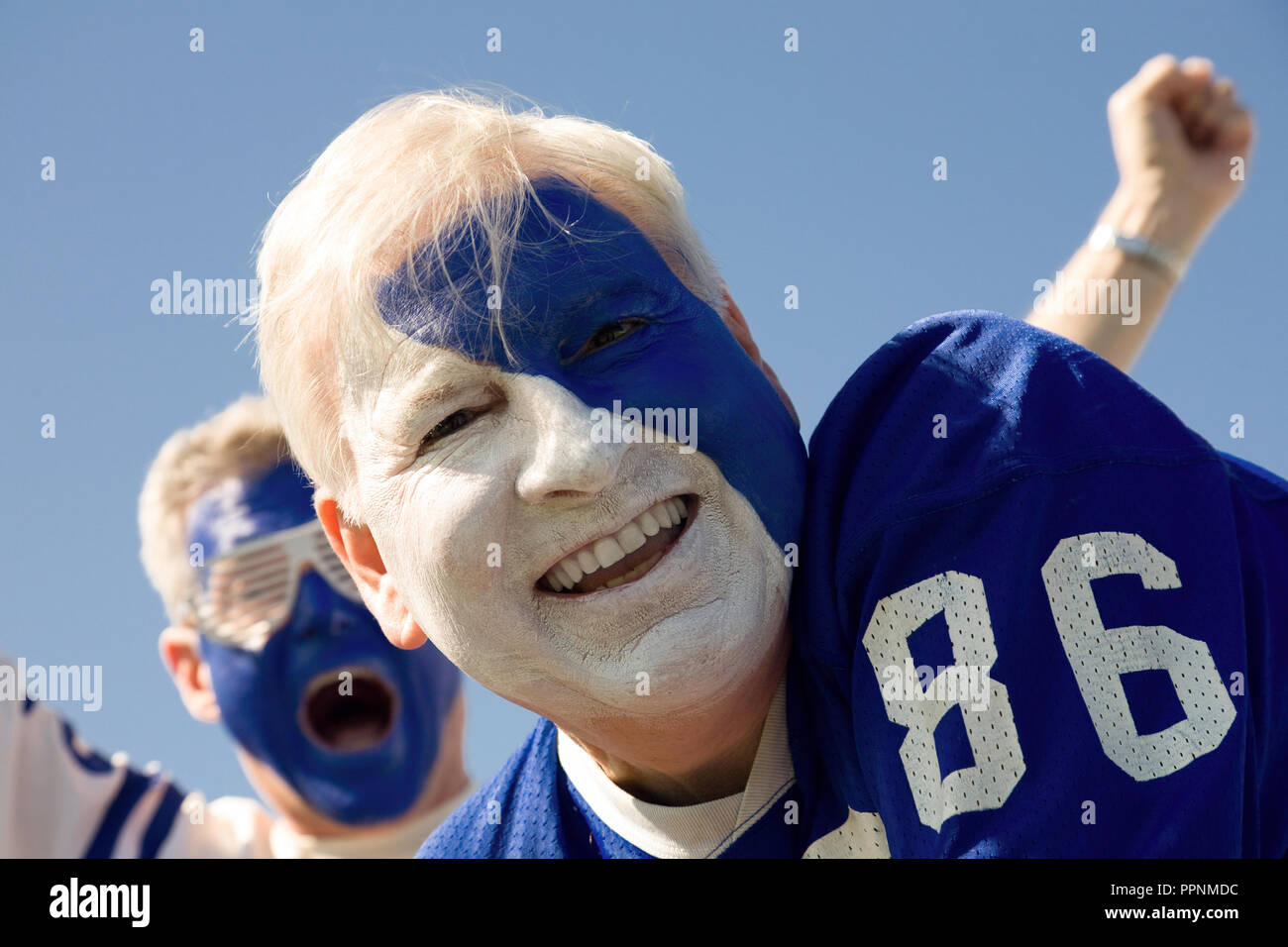 Mature Enthusiastic Sports Fans with Painted Faces at a Football Game ...