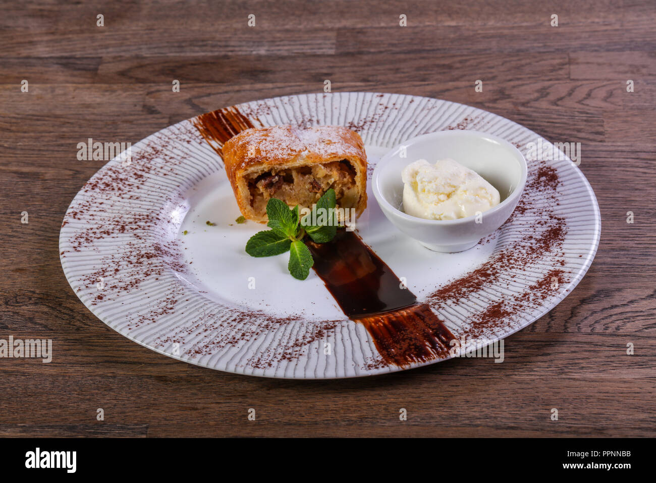 Apple strudel with ice-cream served mint leaves Stock Photo - Alamy