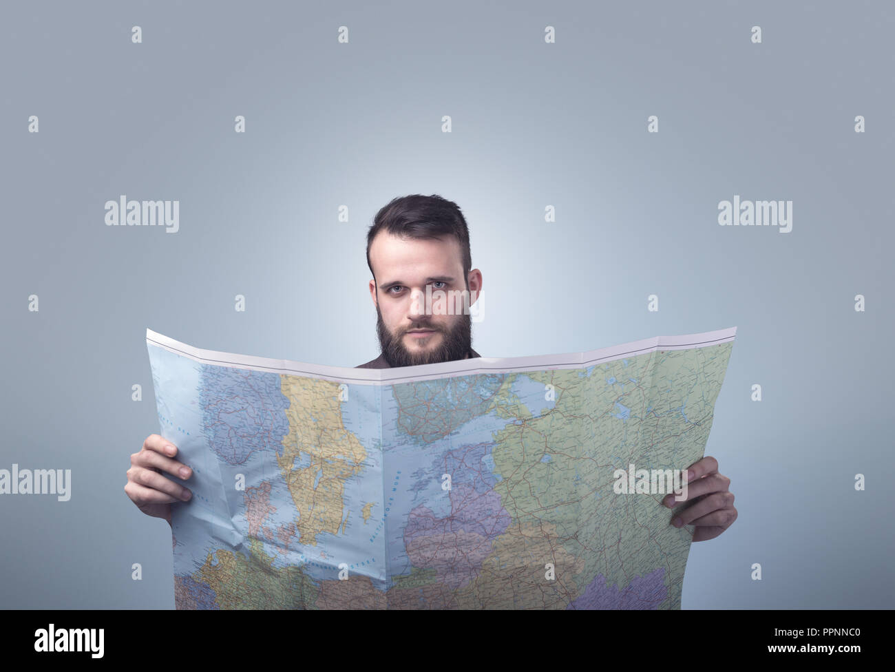Handsome young man holding map Stock Photo - Alamy