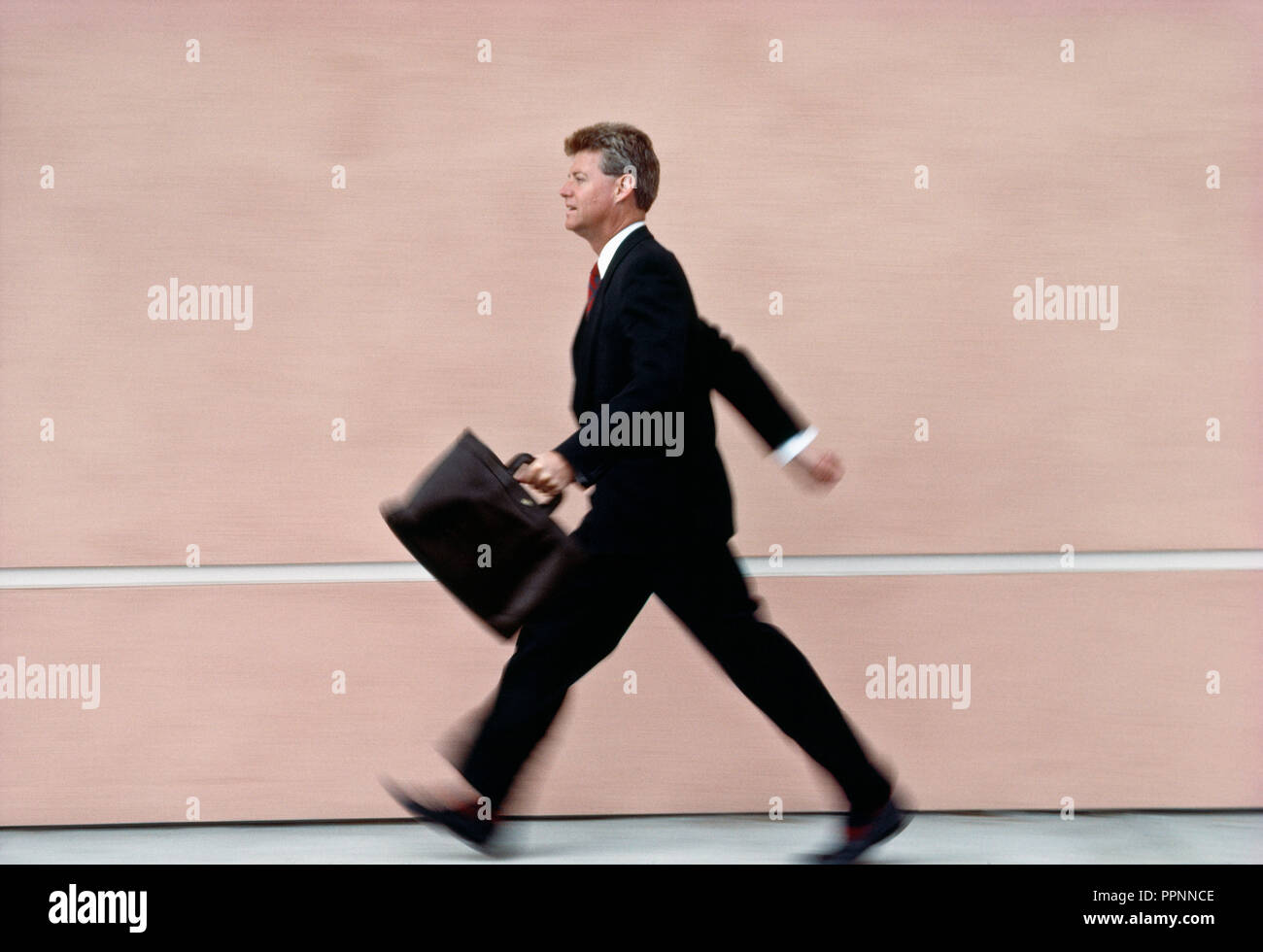 Businessman with Briefcase on the Run, USA 1980s Stock Photo - Alamy