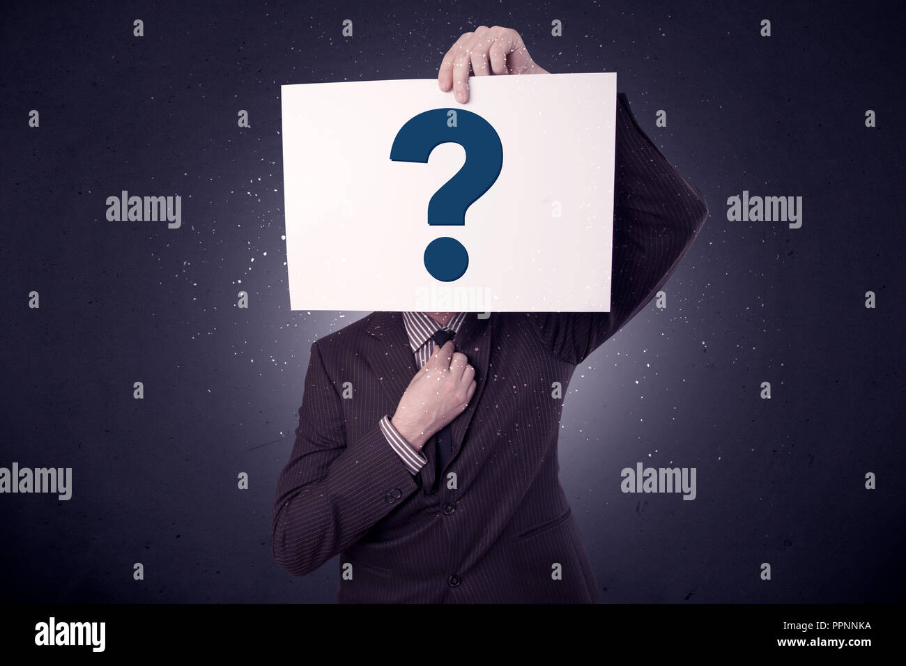 Young businessman hiding behind a question mark drawn on paper Stock ...