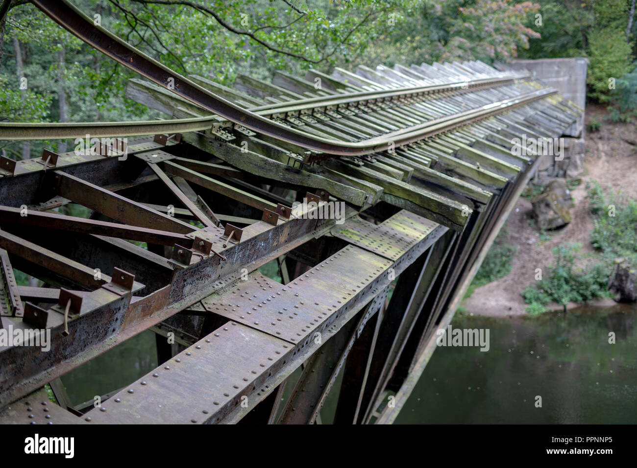 Old destroyed railway bridge over the river. Railway crossing blown up ...