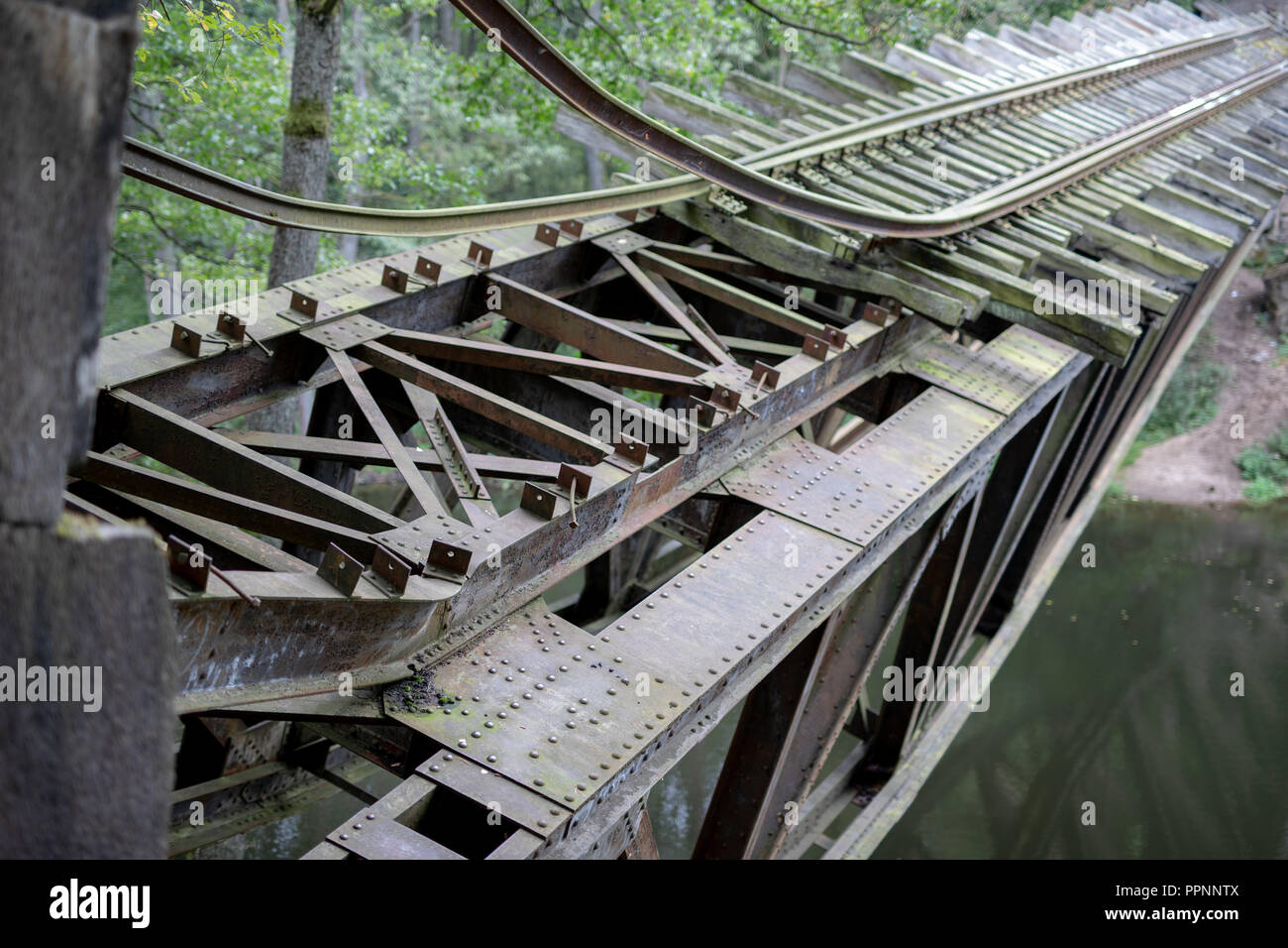 Old destroyed railway bridge over the river. Railway crossing blown up ...