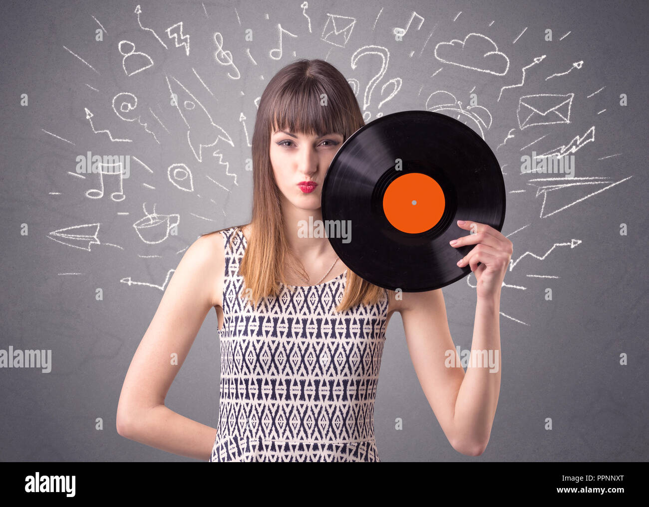 Young lady holding vinyl record on a grey background with mixed ...