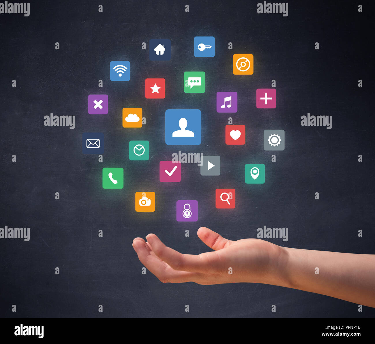Colorful applications hovering over young hand Stock Photo - Alamy