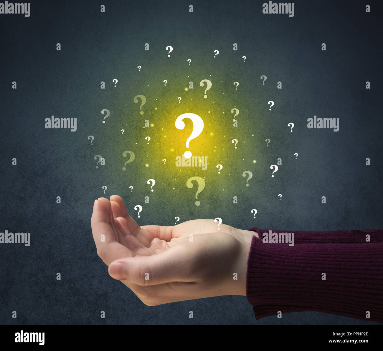 Yellow question marks hovering over young hand Stock Photo - Alamy