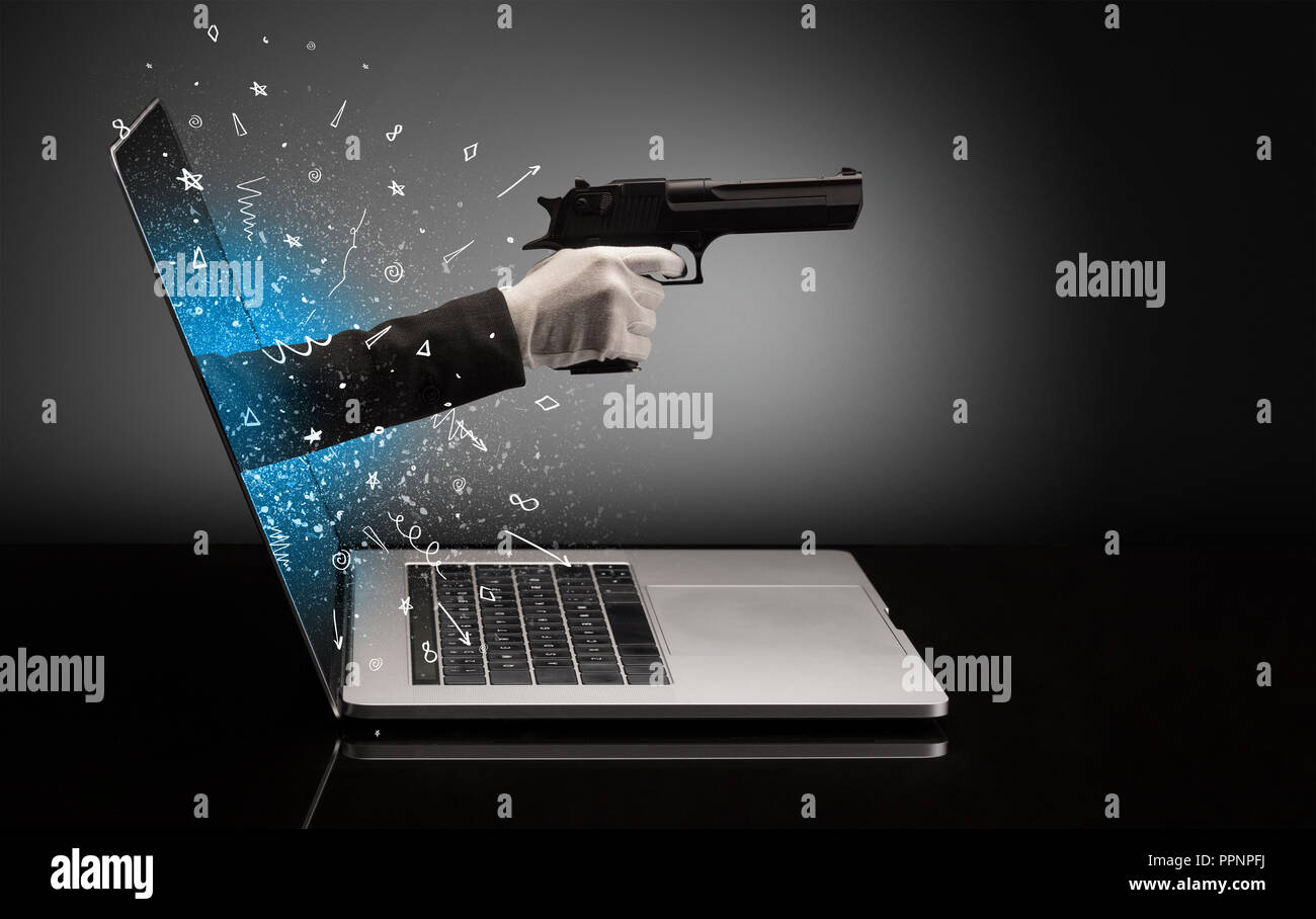 Hand with gun coming out of a laptop with sparkling effects Stock Photo ...