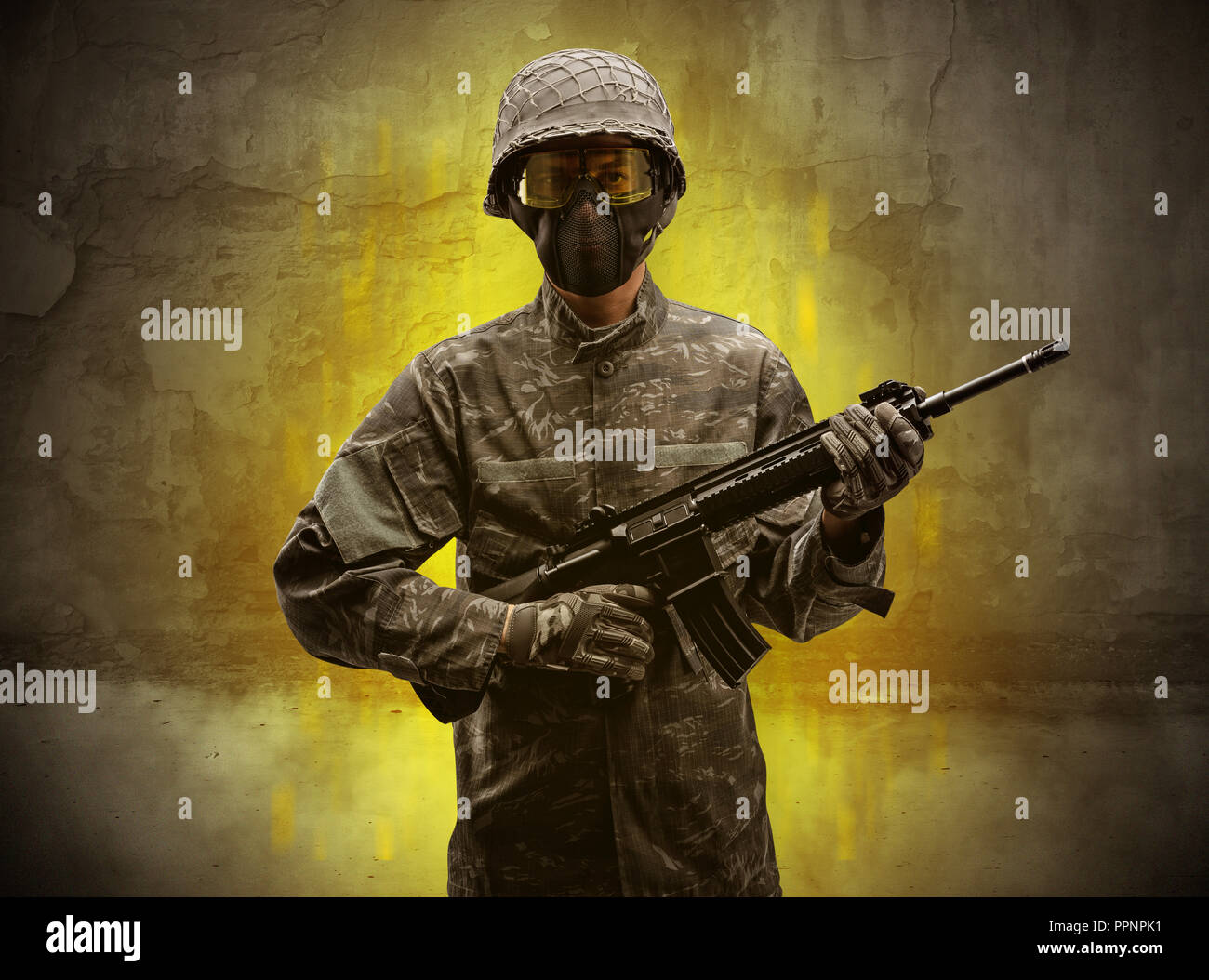 Hazard, menace soldier in a ruined crumbly building with arms on his ...