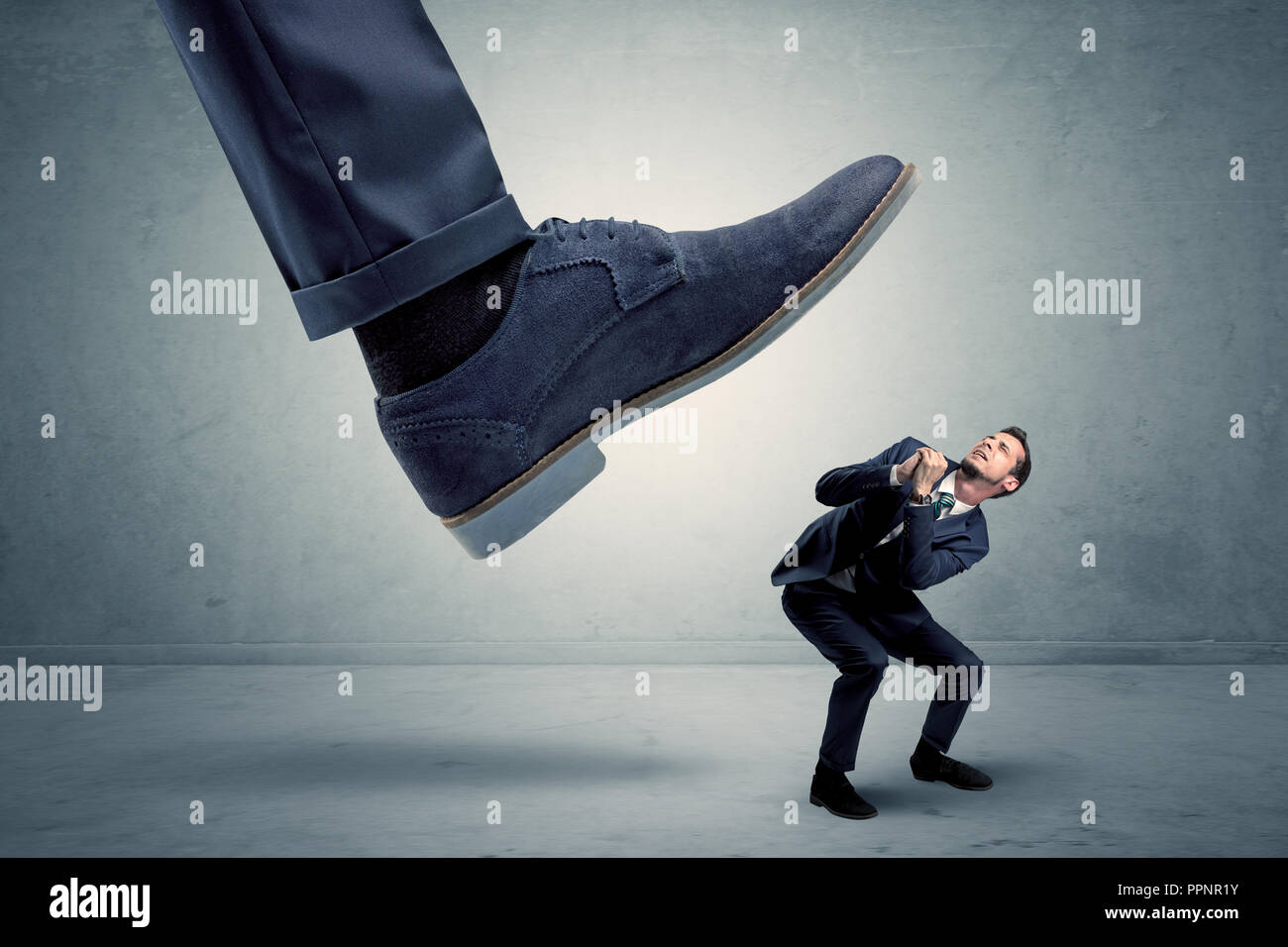 Demoralised employee symbolized by small man getting trampled Stock ...