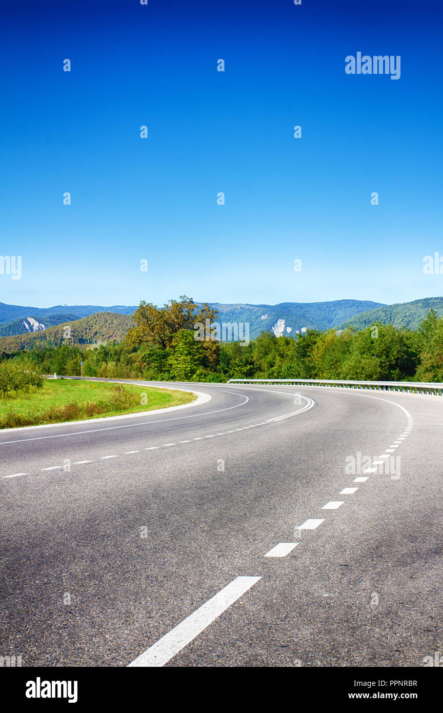 The road in mountainous terrain, sharp turns. Summer landscape ...