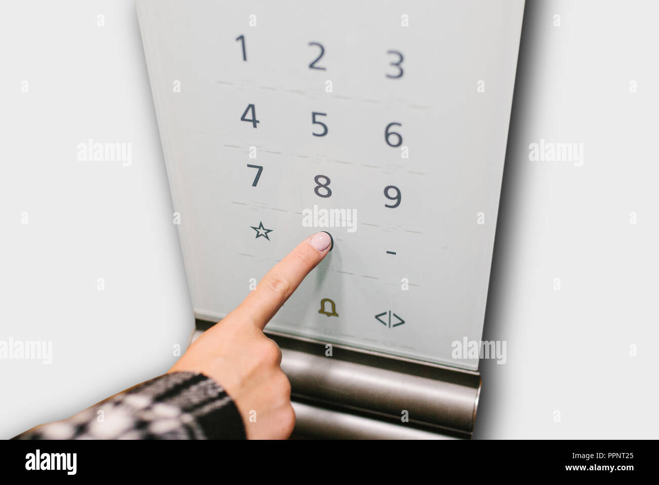 Close-up of a girl pressing a touch button in a modern elevator Stock ...