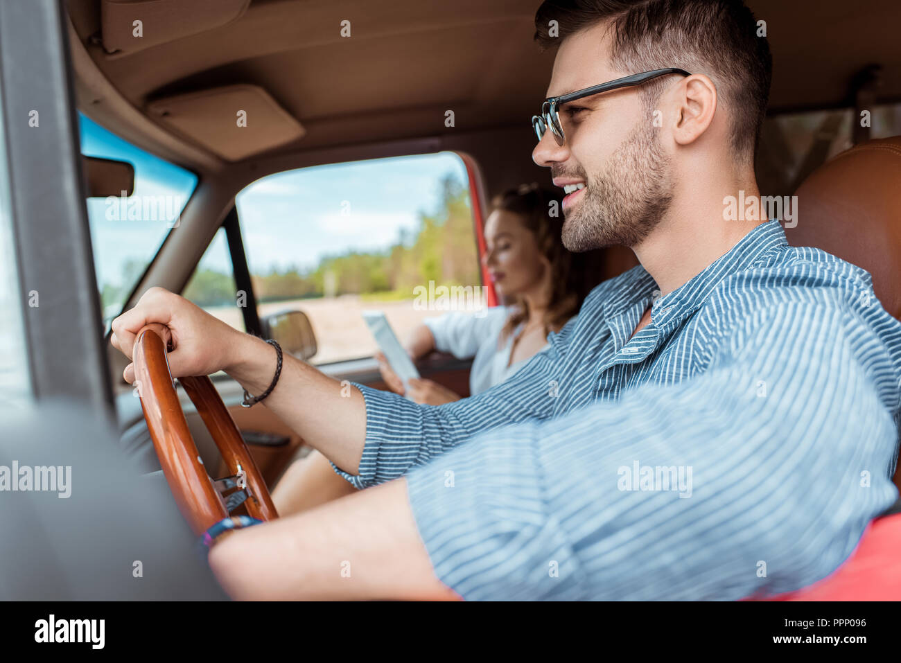 young couple driving car during road trip Stock Photo - Alamy