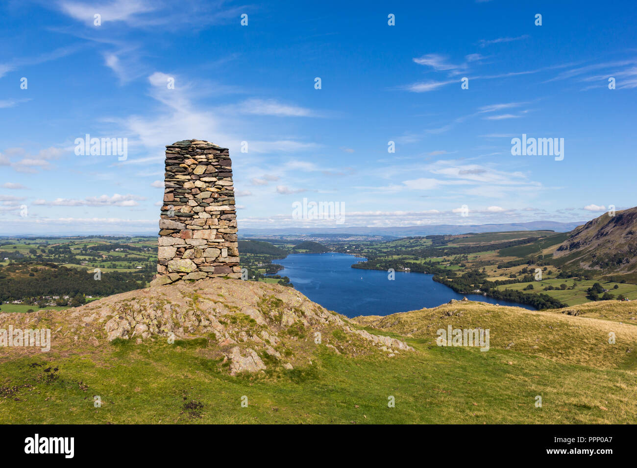 Large stone cairn on the summit of Hallin Fell overlooking Ullswater in ...