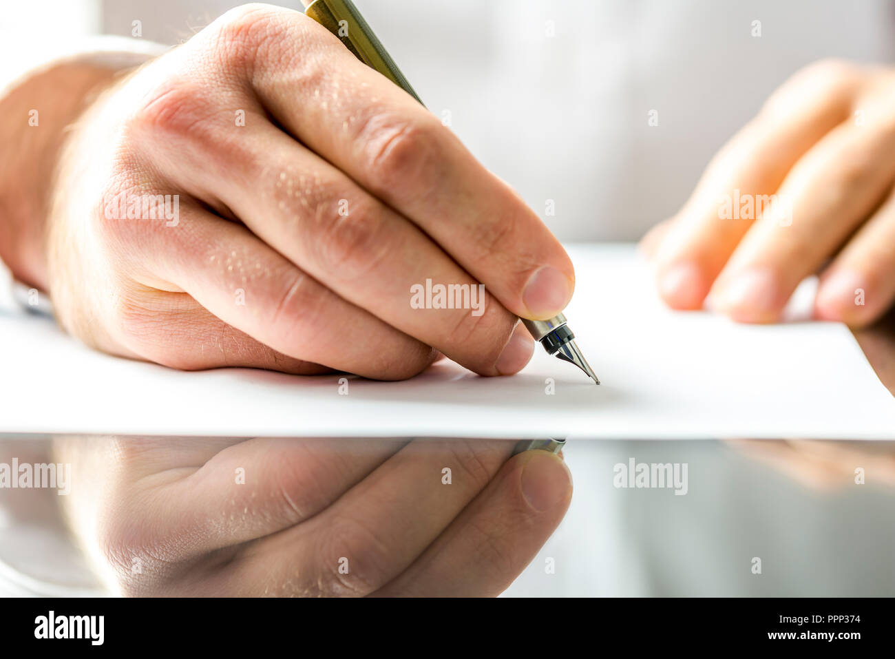 Man writing on a blank paper with ink pen Stock Photo - Alamy