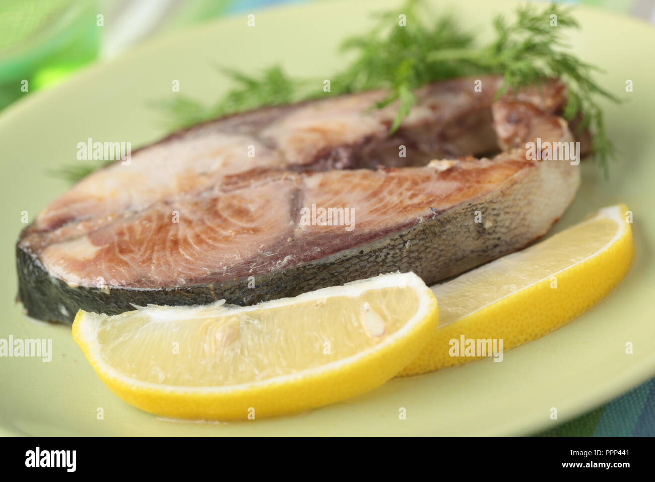 Roasted tuna steak with lemon and dill on a plate closeup Stock Photo ...