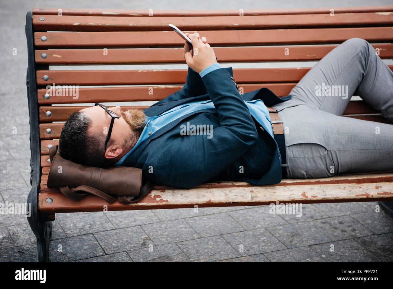 Businessman lying on bench hi-res stock photography and images - Alamy
