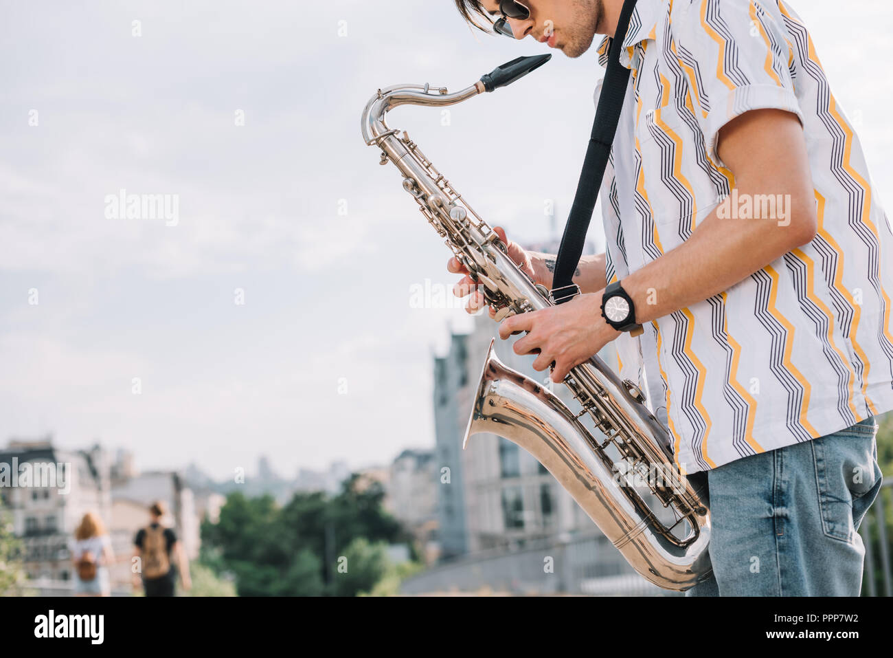 Man playing saxophone street concert hi-res stock photography and ...