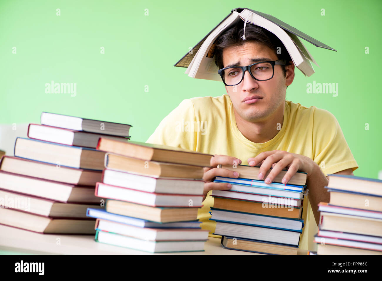 Student with too many books to read before exam Stock Photo - Alamy