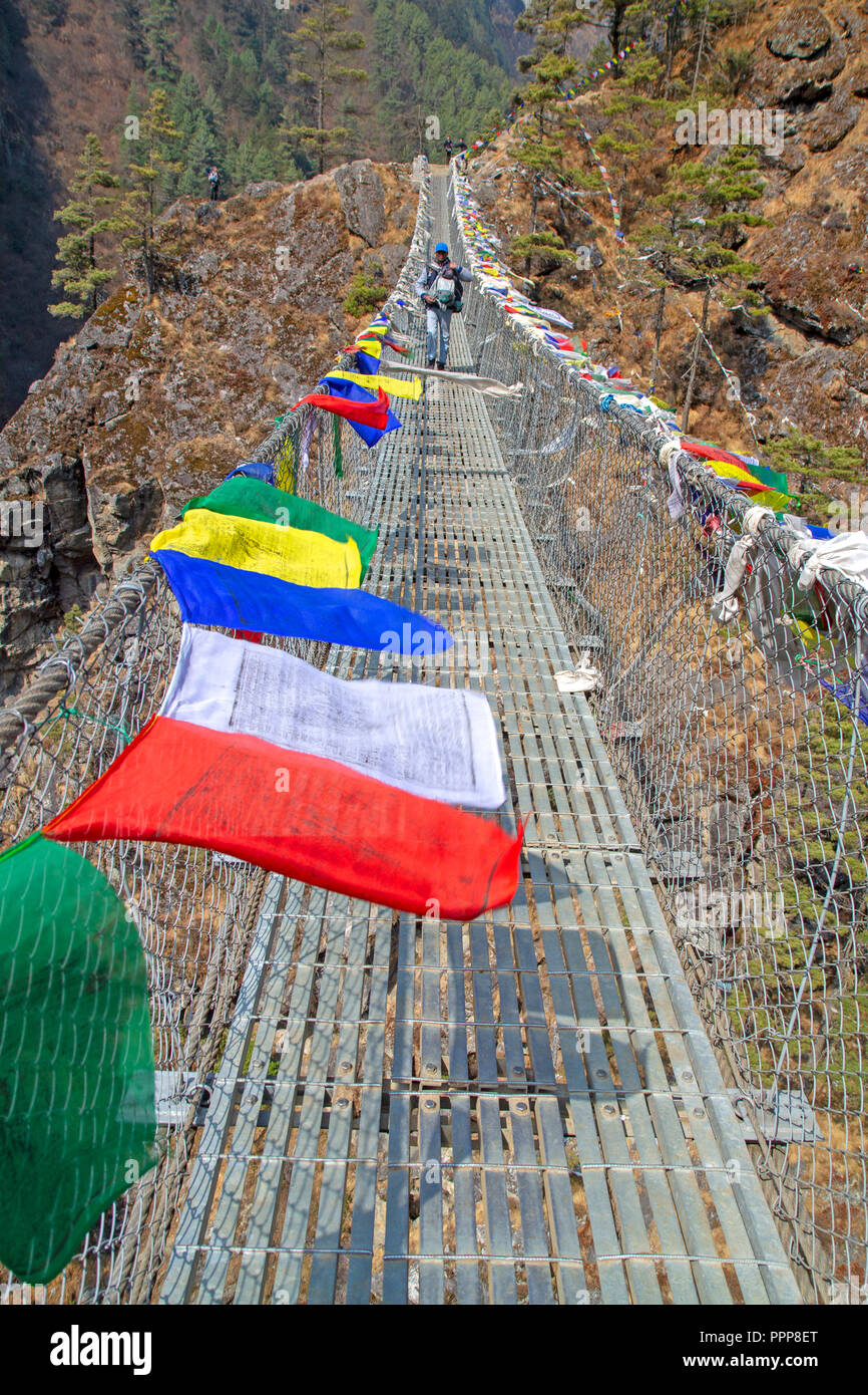Prayer flags on a suspension bridge over the Dudh Kosi on the trail to ...