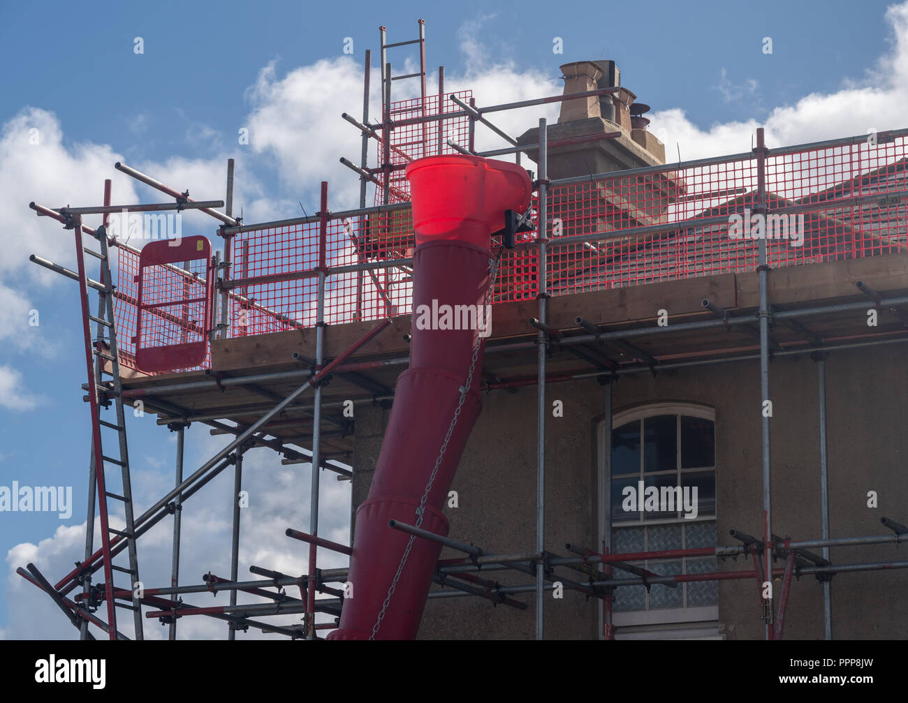 Scaffolding around roof and chimney of stone house Stock Photo - Alamy
