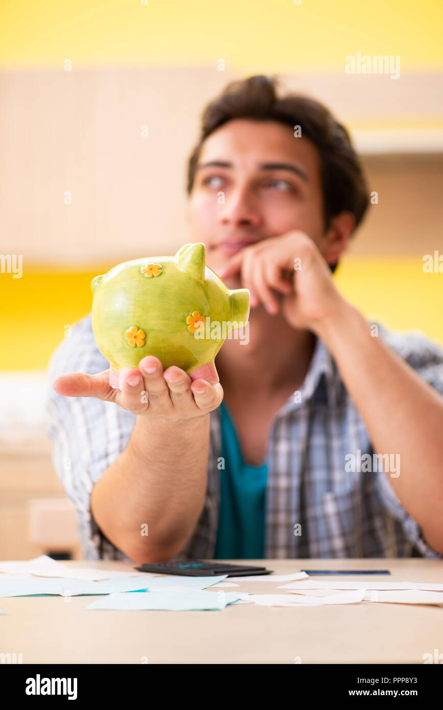 Young man husband in budget planning concept Stock Photo - Alamy