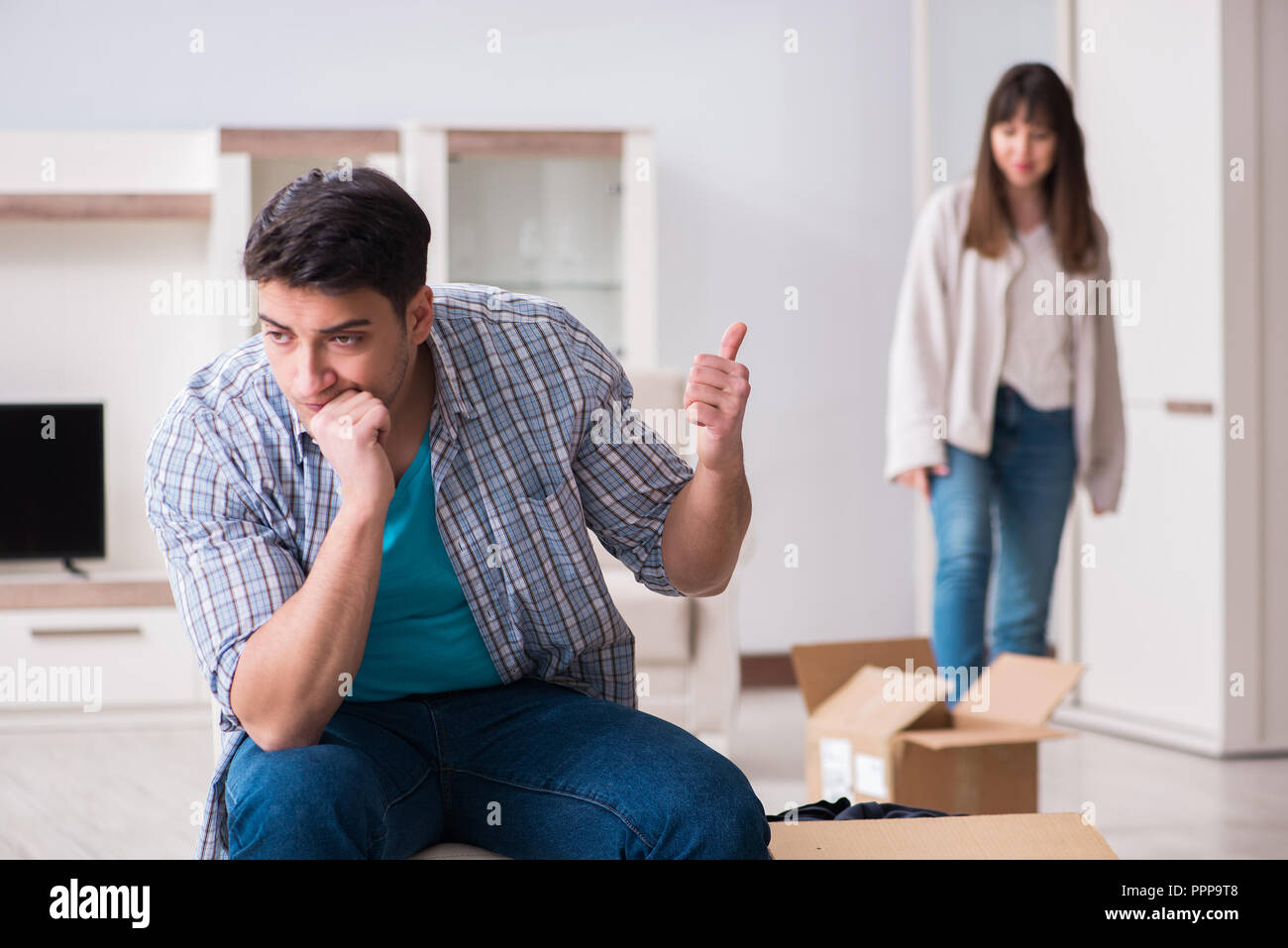Woman evicting man from house during family conflict Stock Photo - Alamy