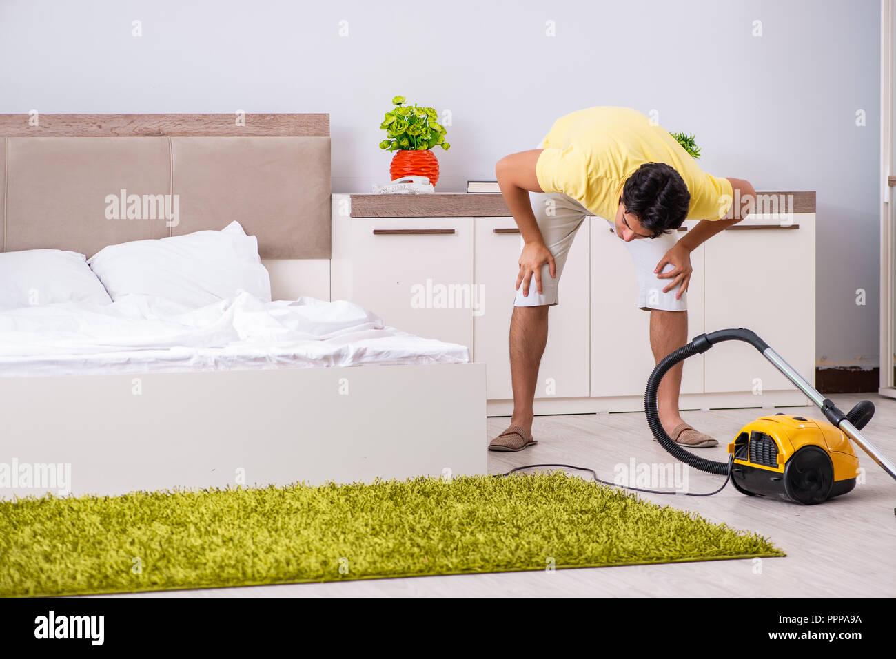Man vacuuming bed hi-res stock photography and images - Alamy