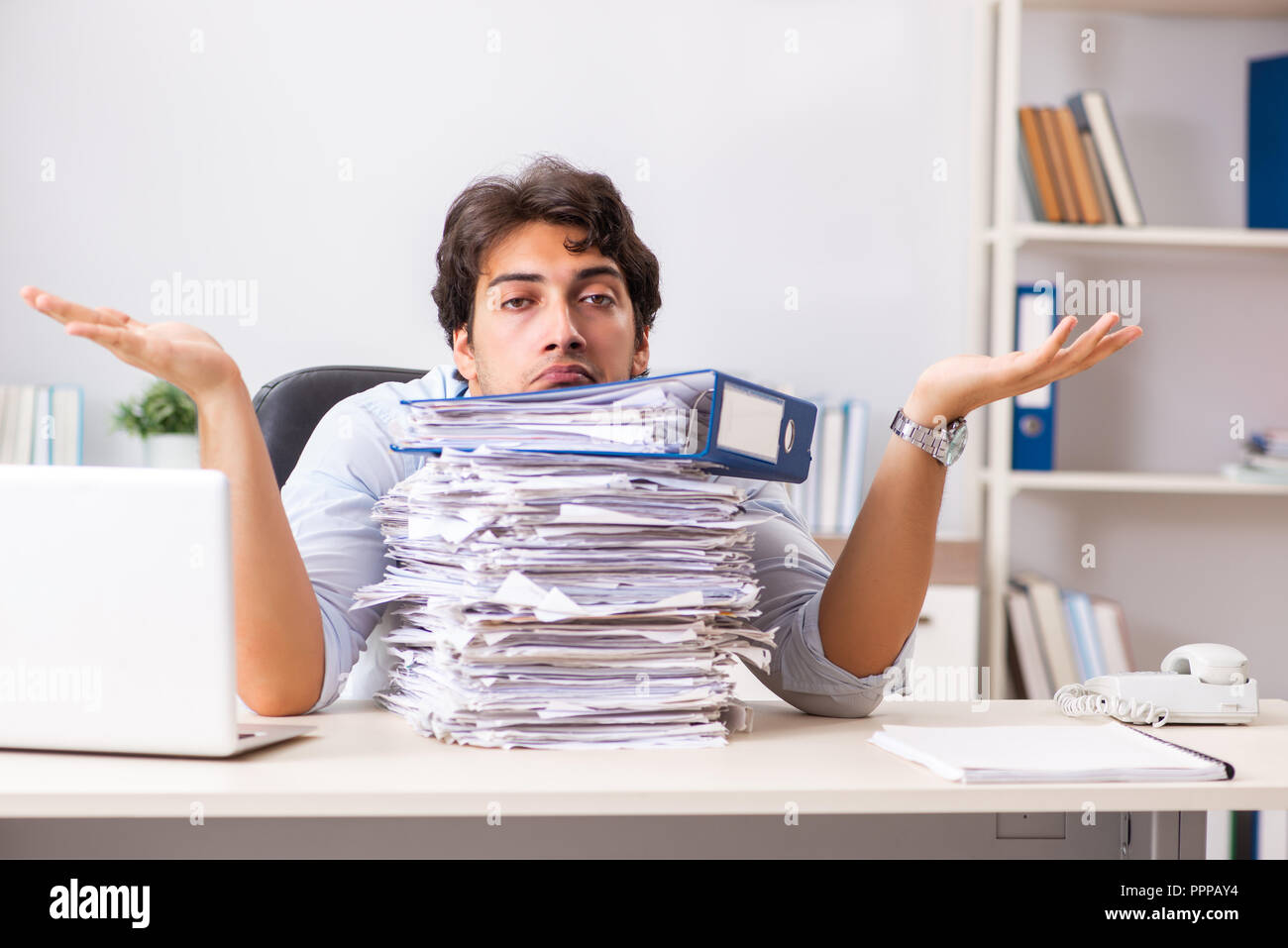 Overloaded busy employee with too much work and paperwork Stock Photo ...