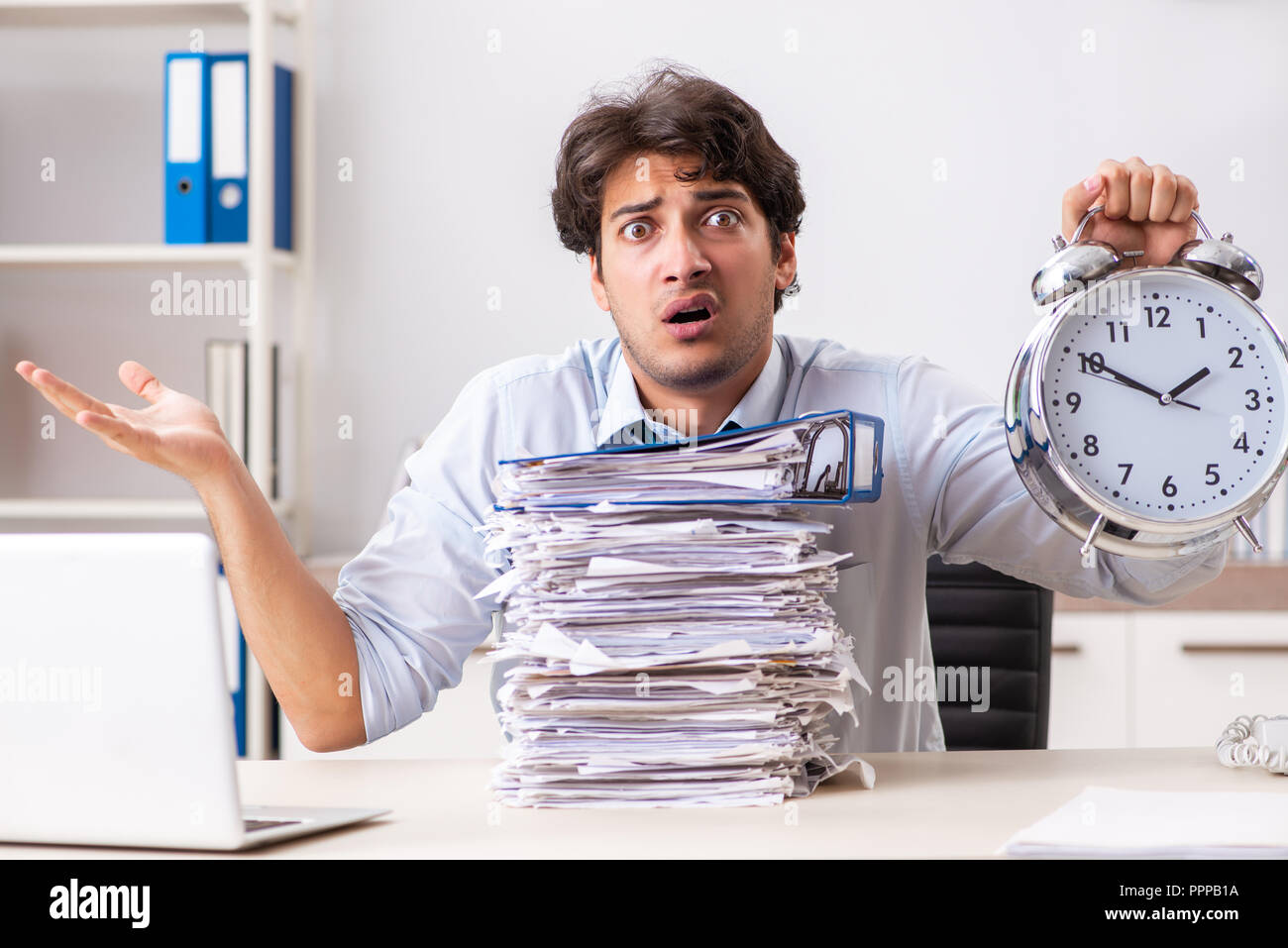 Overloaded busy employee with too much work and paperwork Stock Photo ...