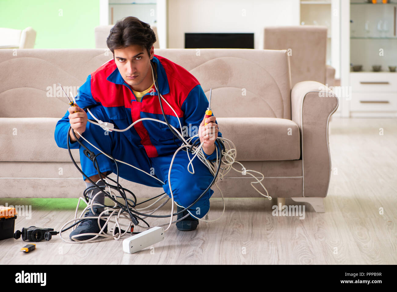 Electrician contractor with tangled cables Stock Photo - Alamy