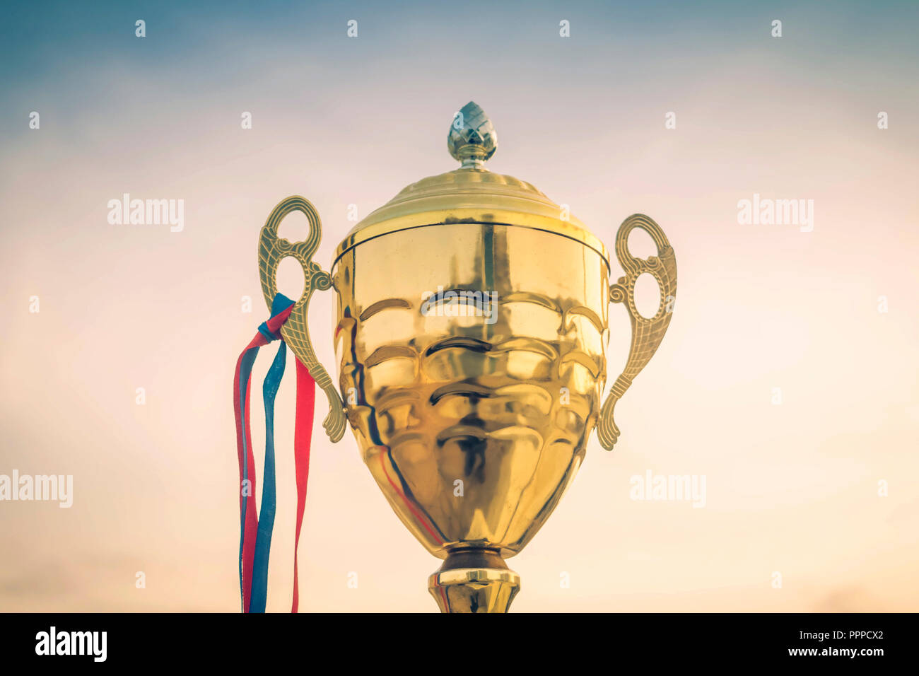 Winner trophy on sky background Stock Photo - Alamy