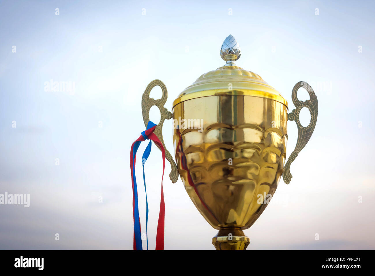 Winner trophy on sky background Stock Photo - Alamy
