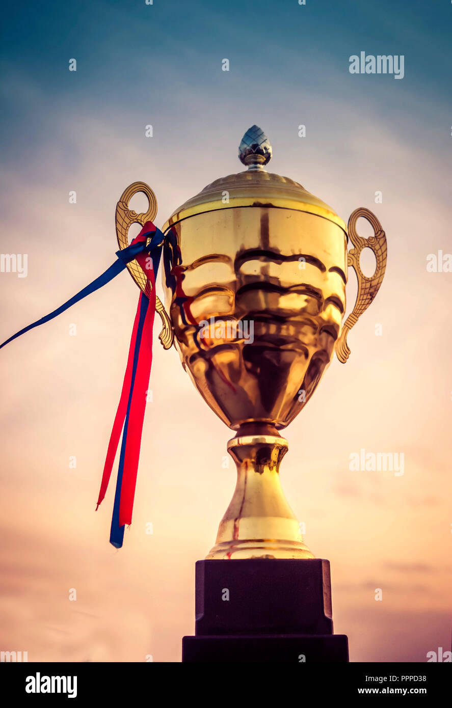 Winner trophy on sky background Stock Photo - Alamy