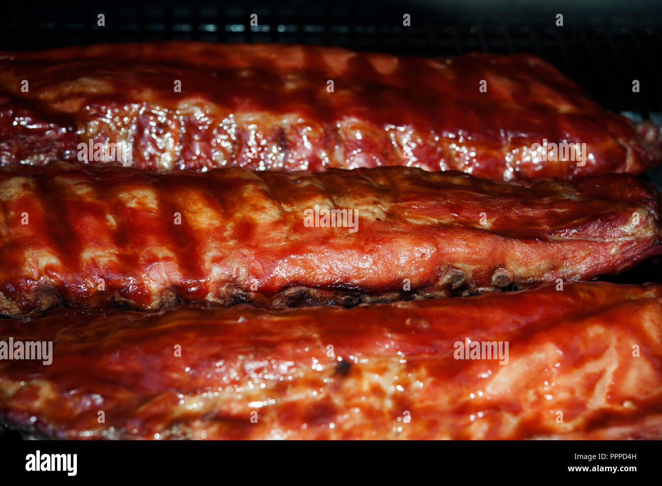 Racks of pork ribs cooking on the bar-b-que Stock Photo - Alamy