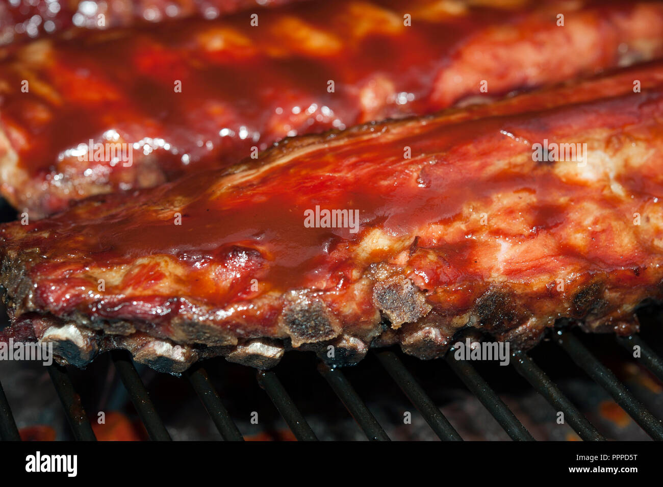 Racks of pork ribs cooking on the bar-b-que Stock Photo - Alamy